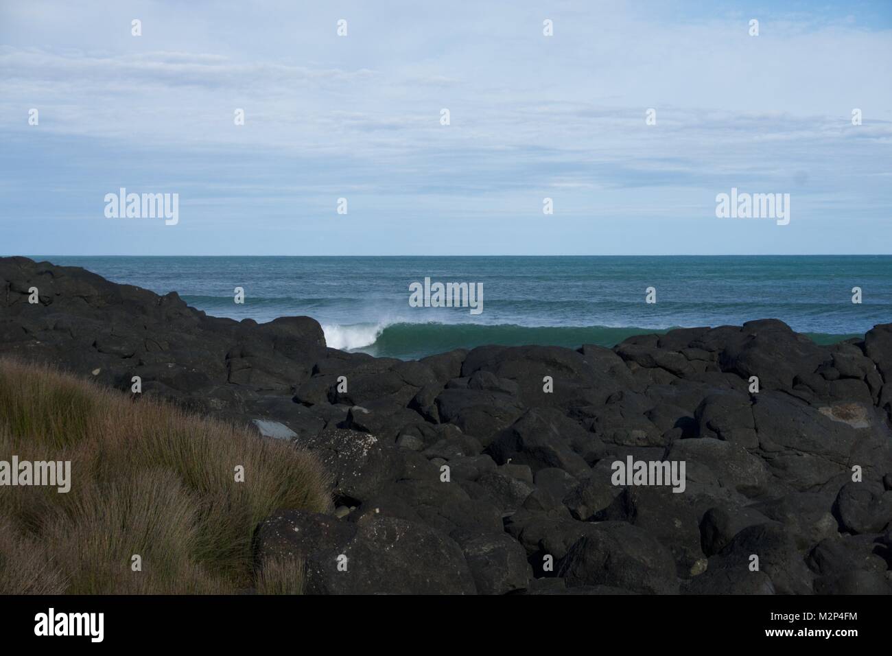 Waves rocks & wind Stock Photo - Alamy