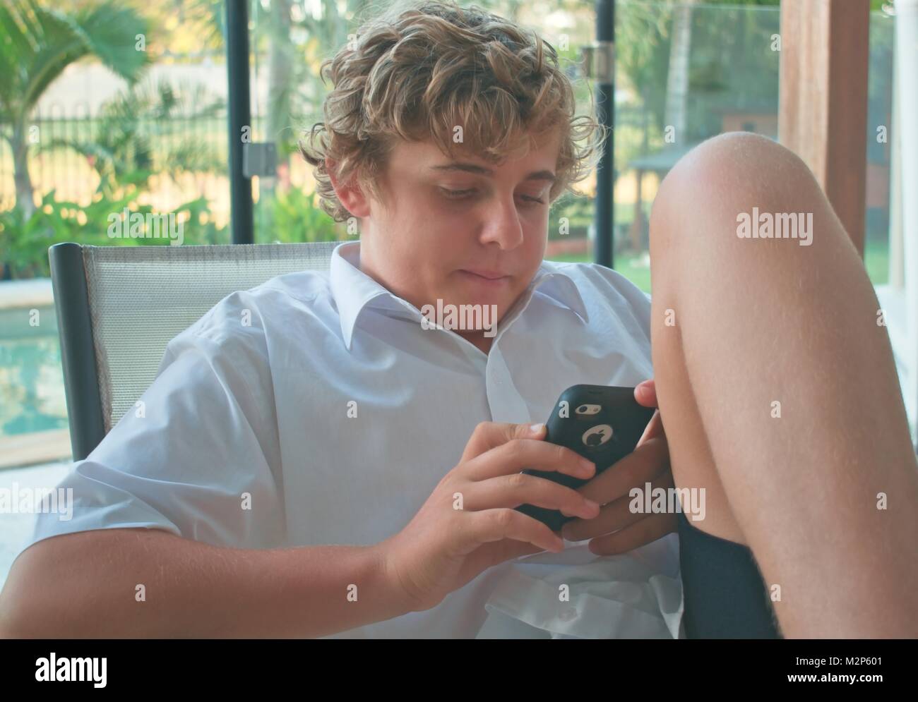 Boy texting iphone hi-res stock photography and images - Alamy