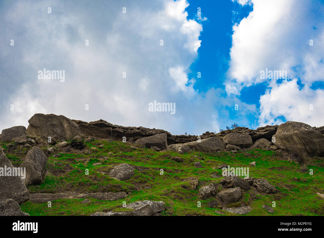 Rocks fragments in the highlands, green meadow Stock Photo - Alamy