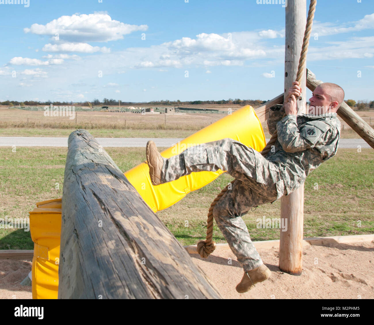 A member of the Oklahoma Army National Guard swings through an obstacle ...