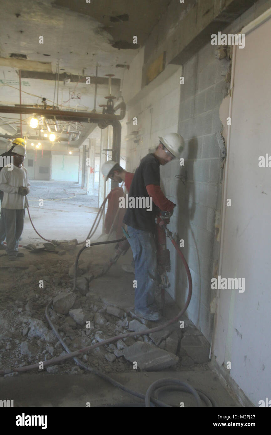 Jacob Meredith (right) and Steven Tringle from AEC use jackhammers to ...