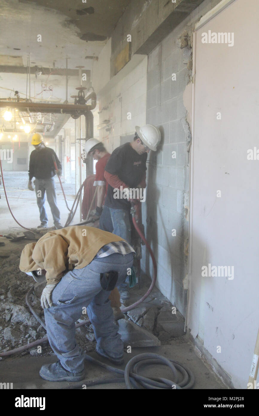 Jacob Meredith (right) and Steven Tringle from AEC use jackhammers to ...