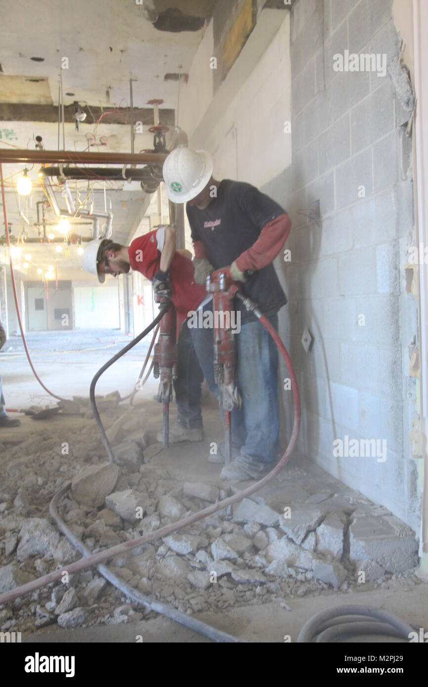 Jacob Meredith (right) and Steven Tringle from AEC use jackhammers to ...