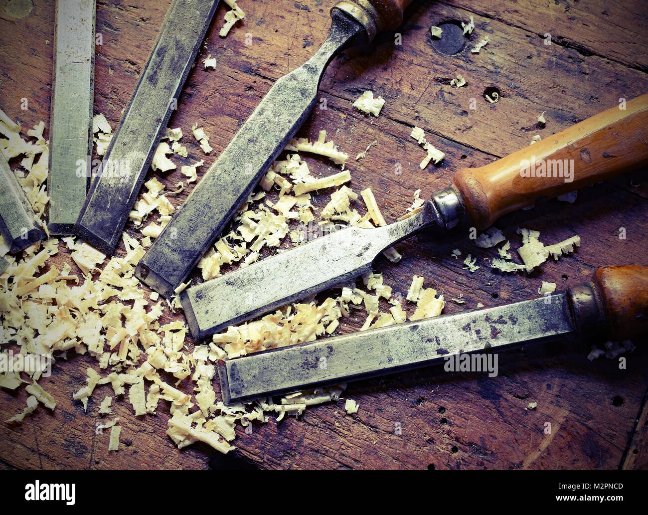 sharp steel blades many chisels and sawdust chippings in Workbench with ...