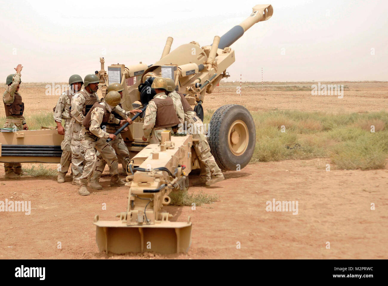 Loading the round. KIRKUSH MILITARY TRAINING BASE, Iraq – An M198 155mm howitzer crew with 105th ...