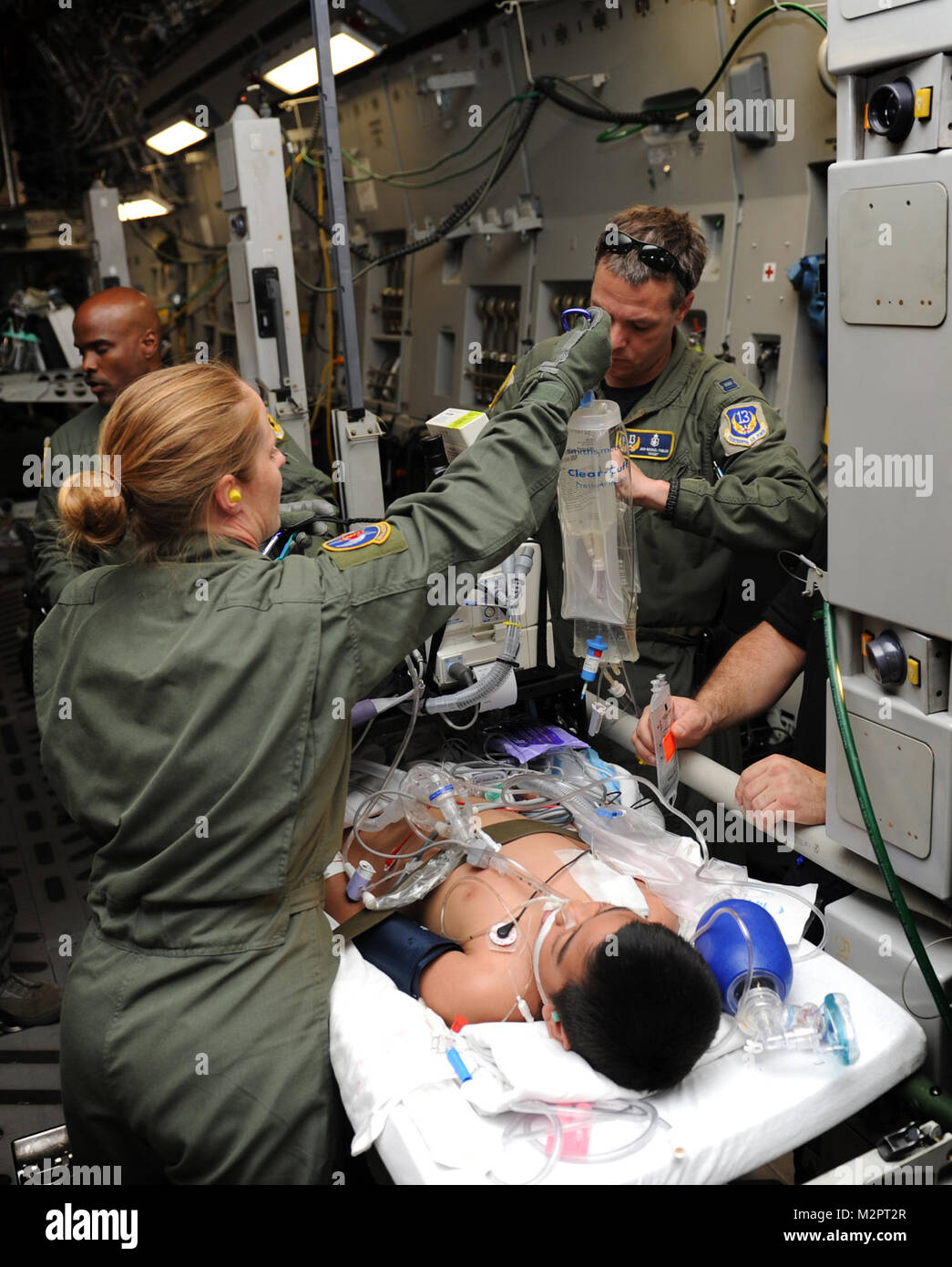 Master Sgt. Molly Quentin and Capt. John-Michael Fowler care for a ...