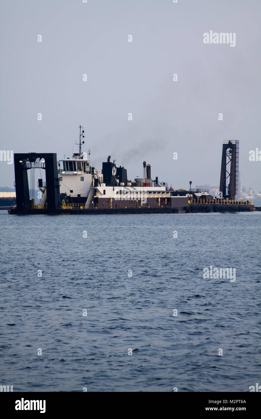 The Norfolk Dredging Company’s hydraulic dredge CHARLESTON works to ...
