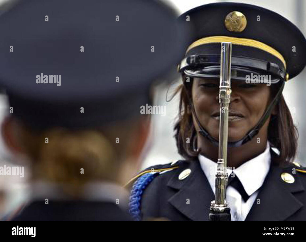 Staff Sgt. Marion Logan prepares for the massing of colors during the ...