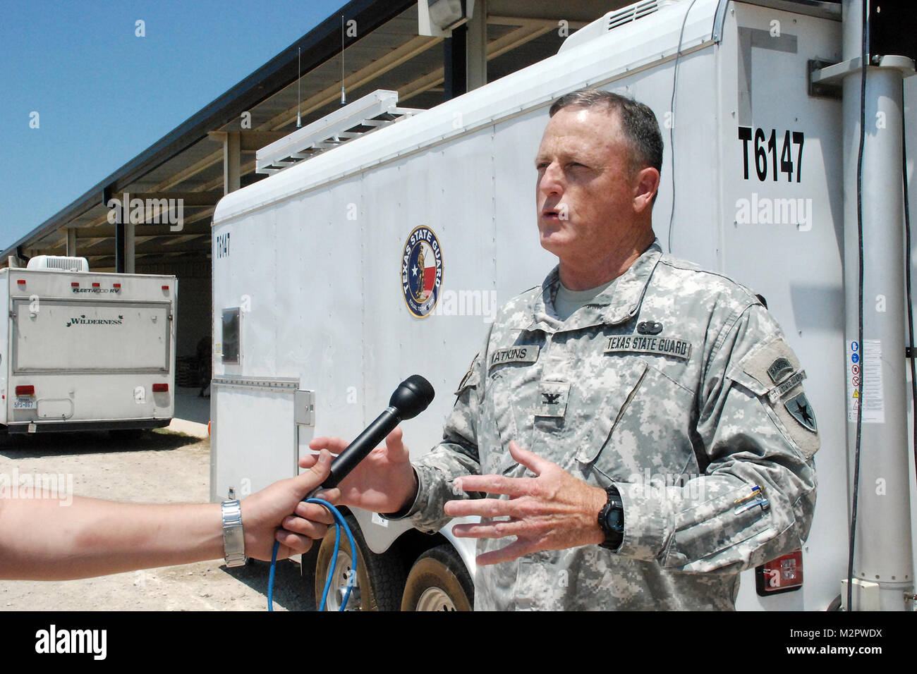 Texas State Guard member, Colonel Paul Watkins, gets interviewed by ...