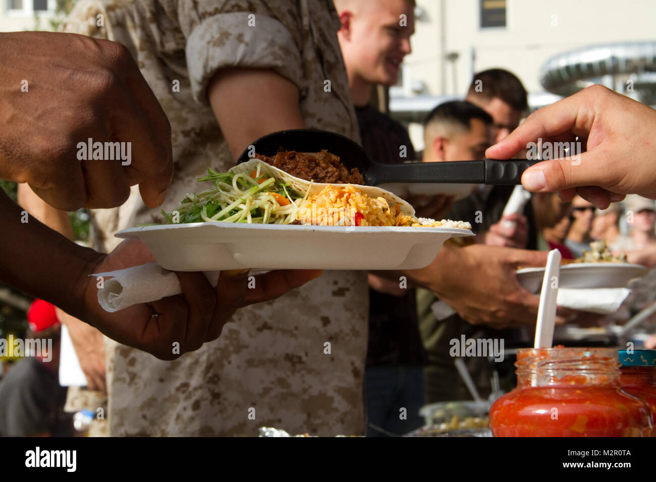 Food is served to a U.S. Marine during a Headquarters and Headquarters ...