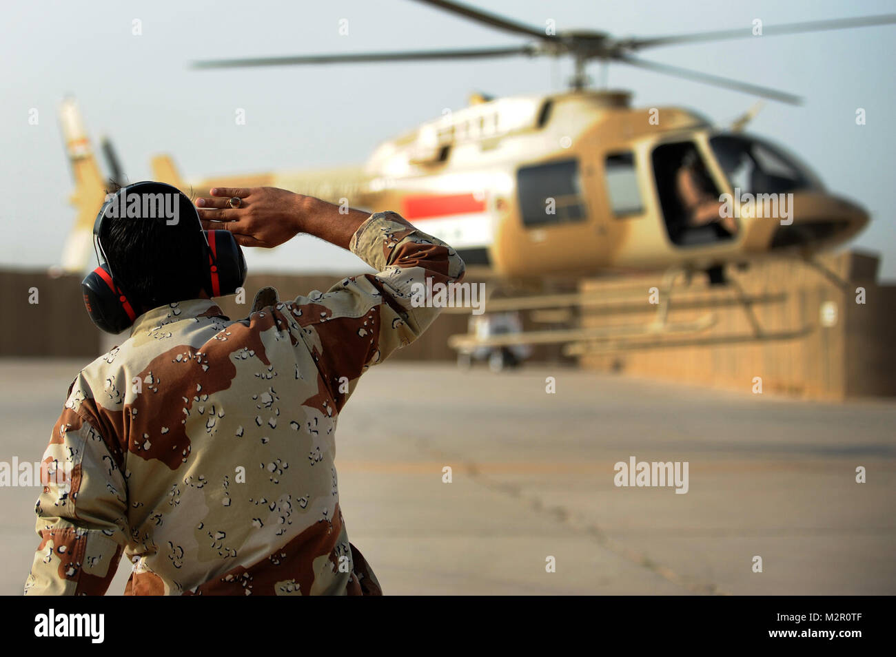 An Iraqi Army Aviation Command, Squadron 21 ground crew member salutes ...