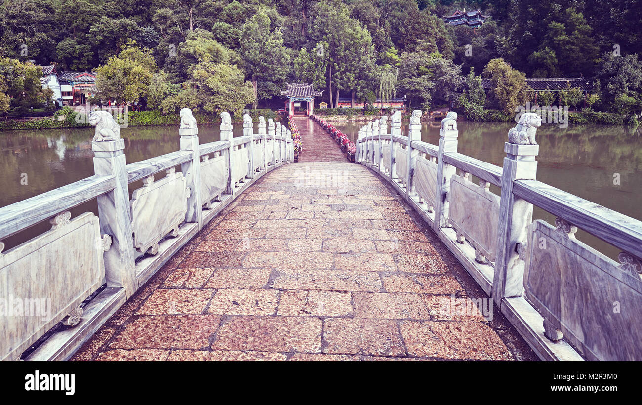 Vintage toned picture of the bridge in the Jade Spring Park in Lijiang ...