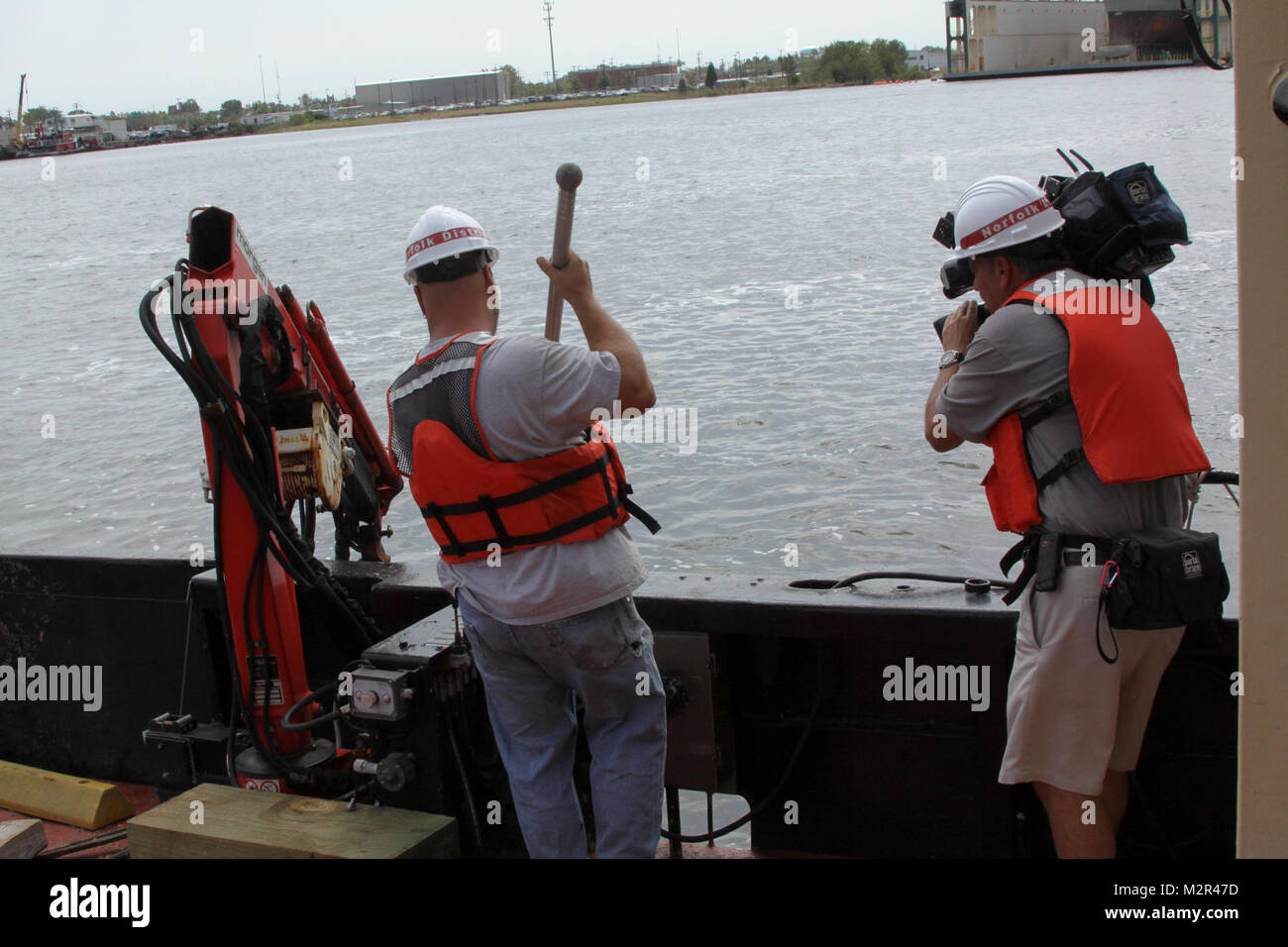 Deckhand James Jarrell secures a large piece of debris prior to ...