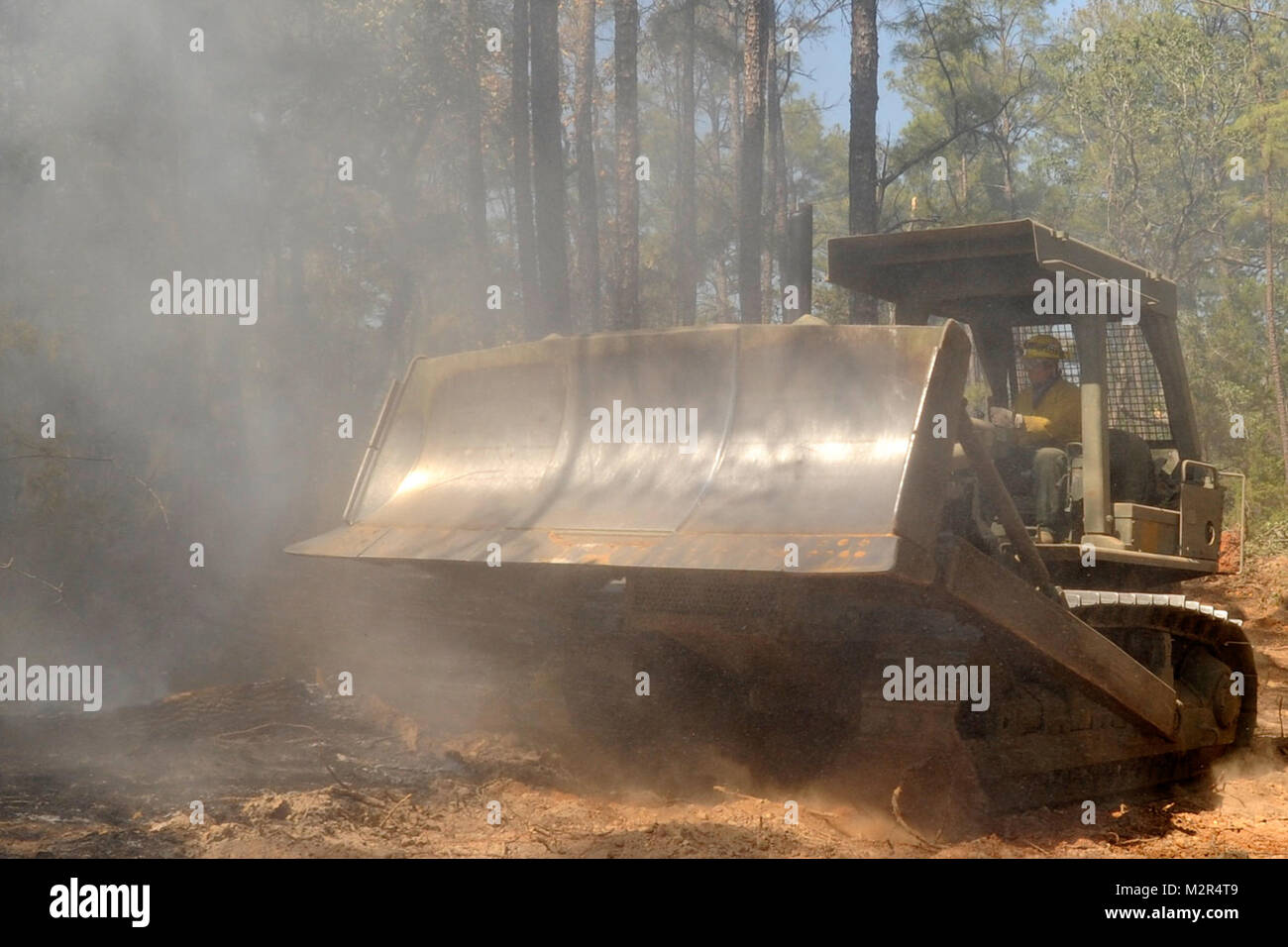 Spc. Brady Burton with the 111th En Bn, TXARNG, clear trees and brush ...