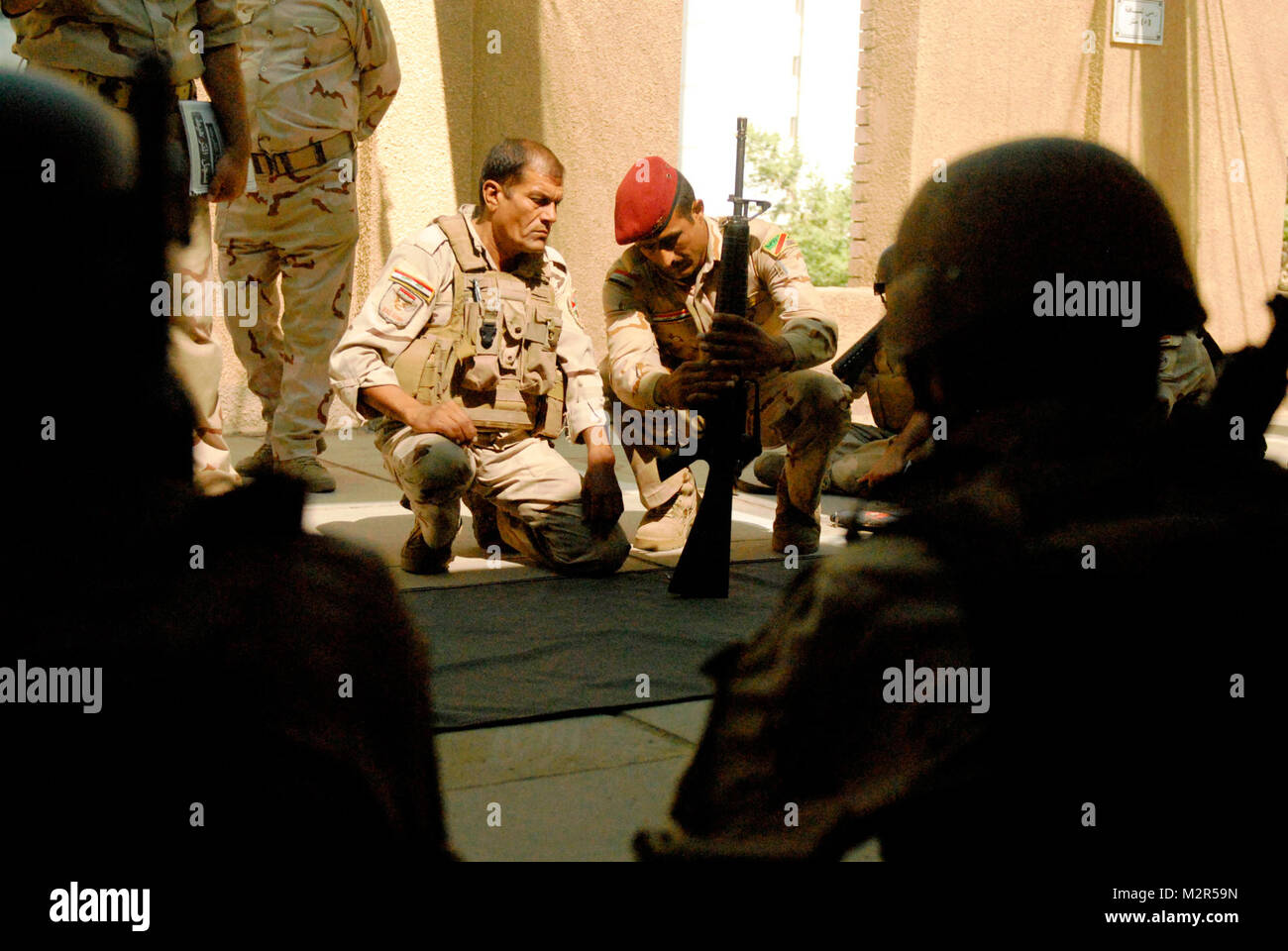 A noncommissioned officer and trainer, right with weapon, with the 11th ...