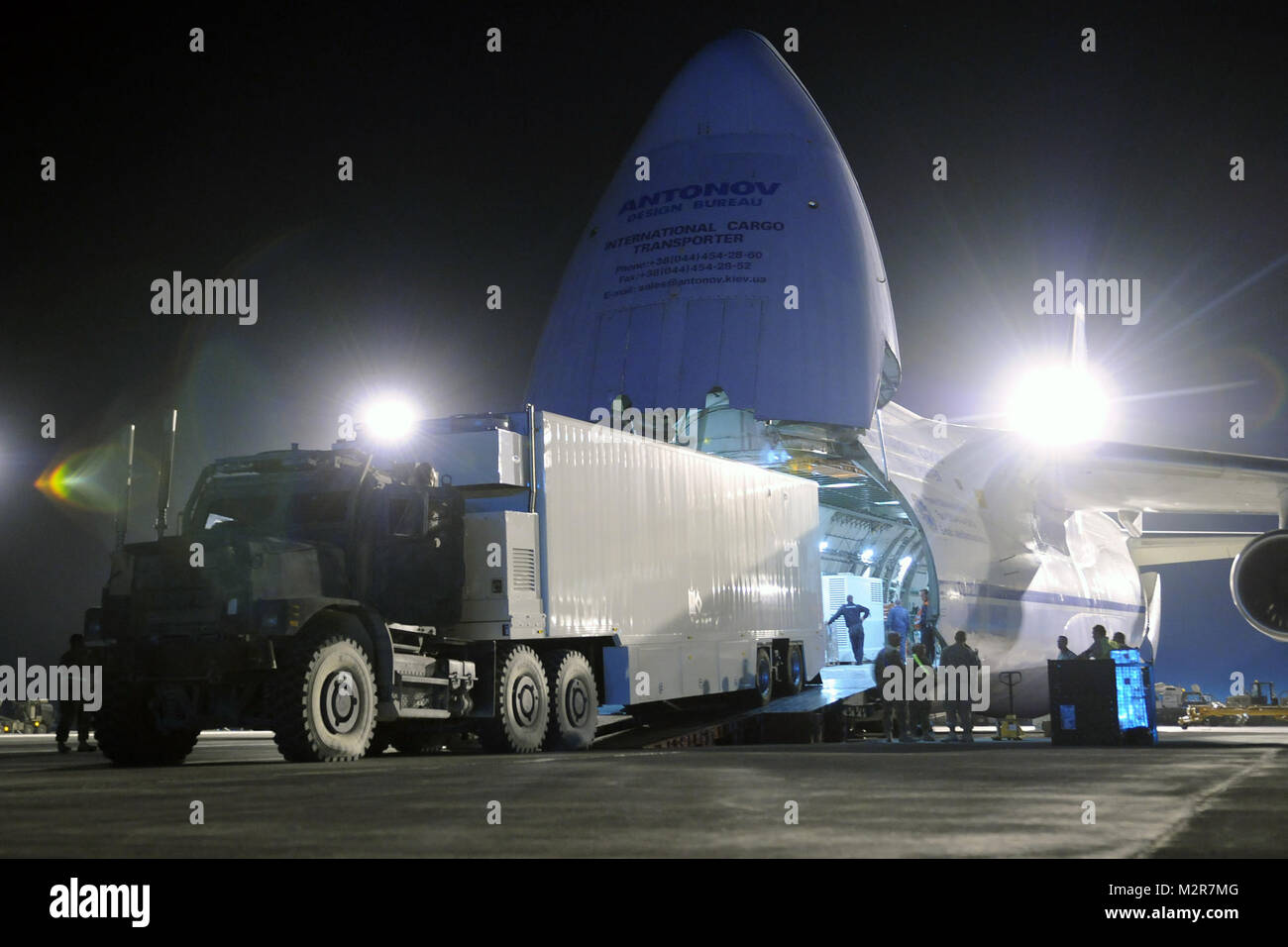 An AMK-31 vehicle drives off the ramp of an Antonov 124-100M aircraft ...