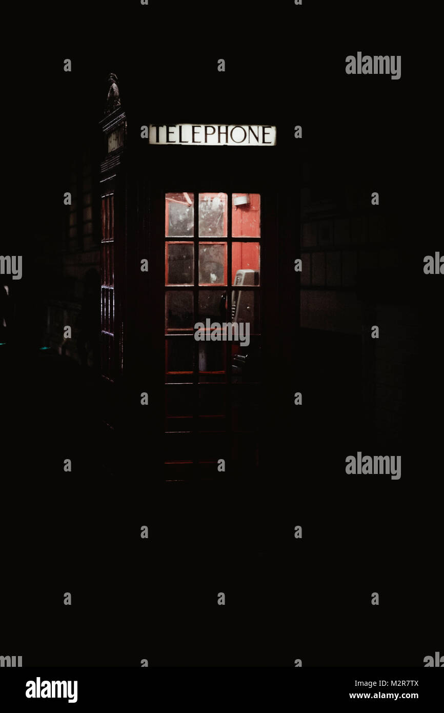 A typical British telephone box at night Stock Photo - Alamy