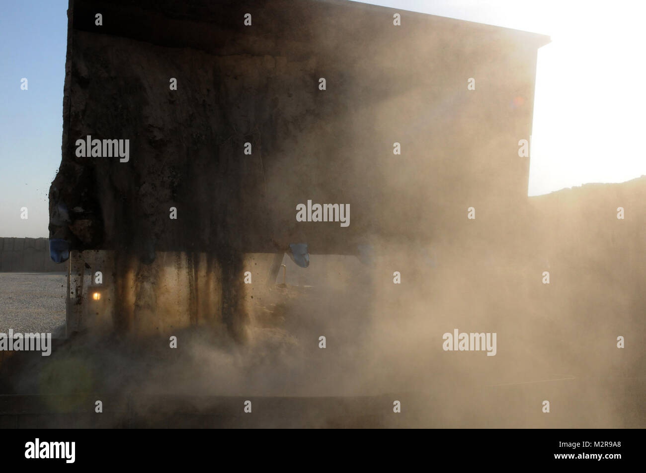 A D7 bulldozer dumps dirt into a Hesco barrier, Oct. 19, at Combat ...