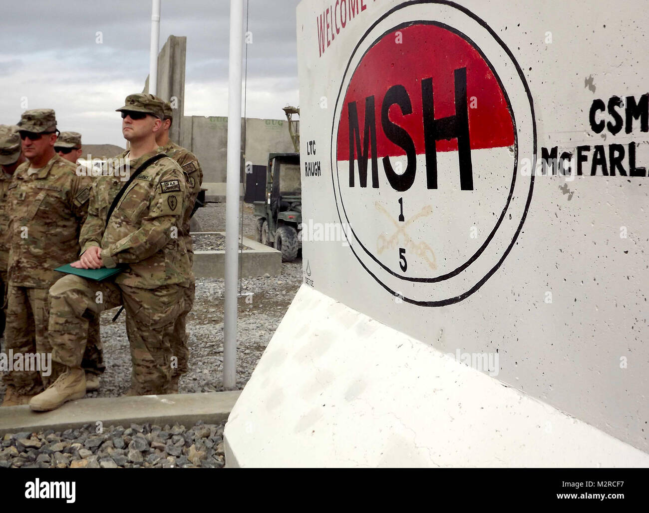 Silhuetted by the units crest painted on a safety barrier, Staff Sgt ...