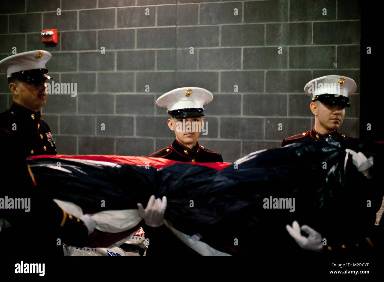 EAST RUTHERFORD, N.J. -- A Marine holds a portion of a large American ...