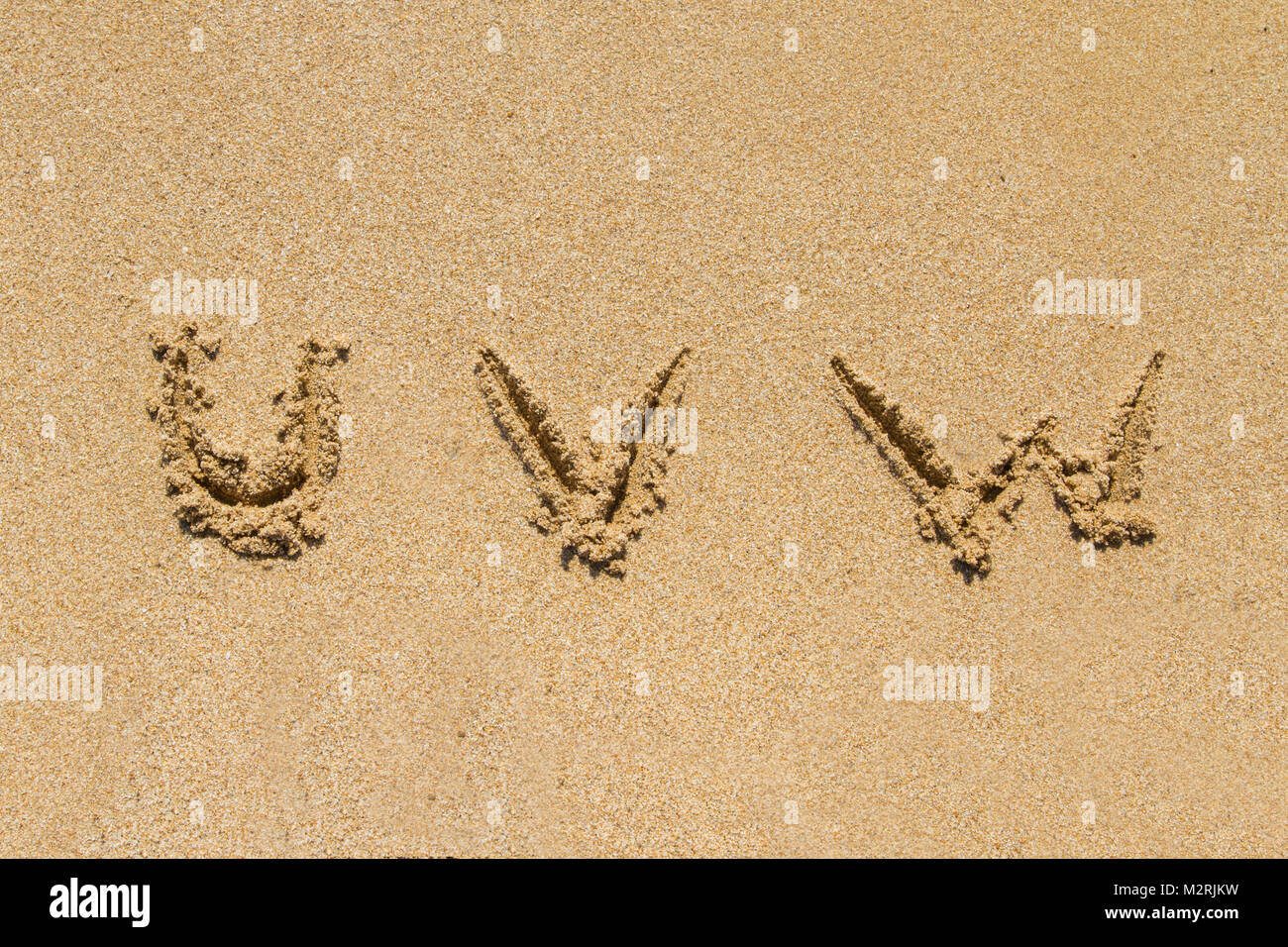 Set of uvw letters of alphabet written on sand with lower case Stock ...