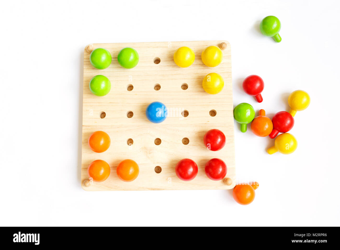 Colored pegs board, wood beads on white background Stock Photo - Alamy