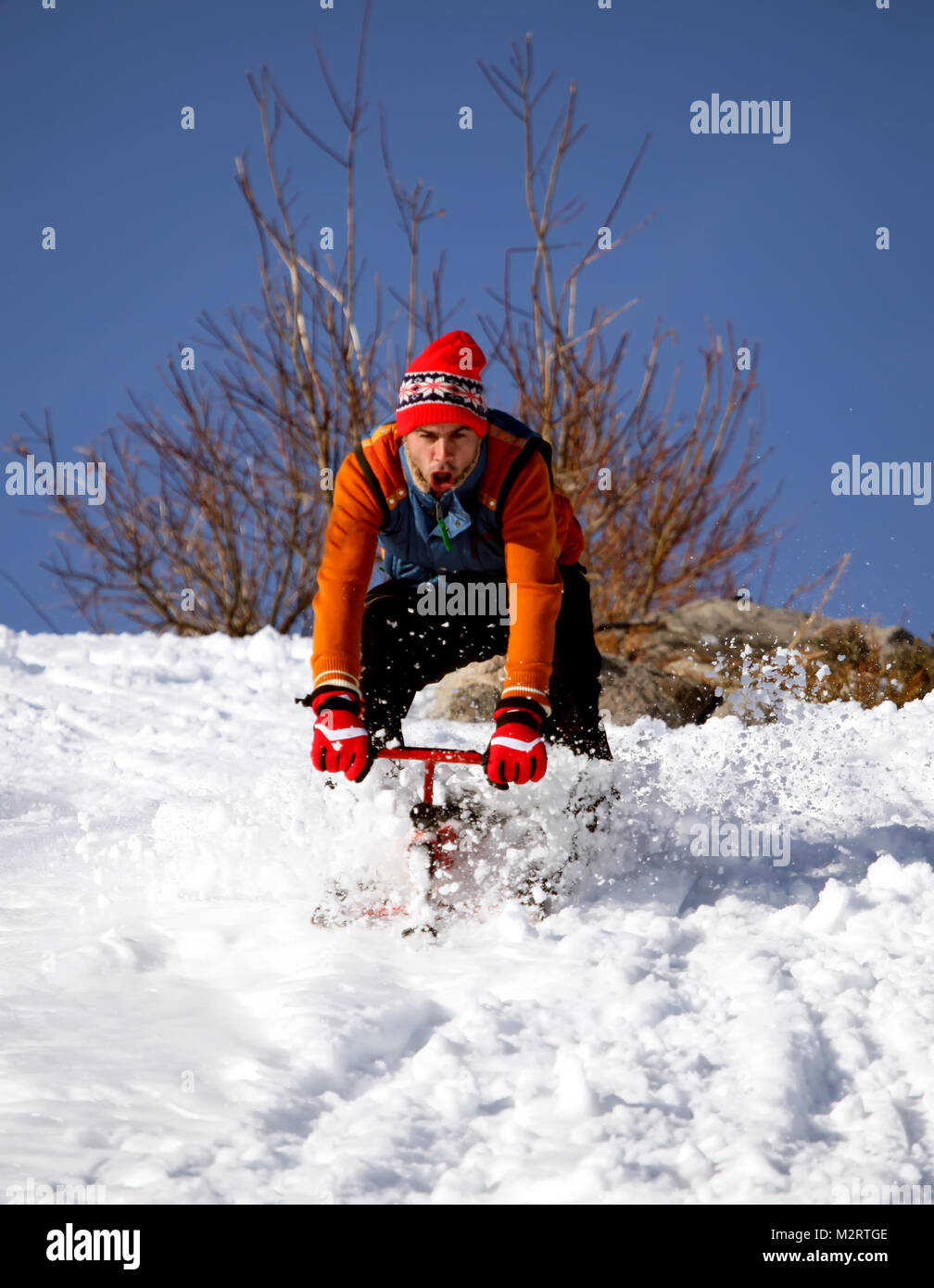 man with funny expresion on the face crashing with sled Stock Photo - Alamy