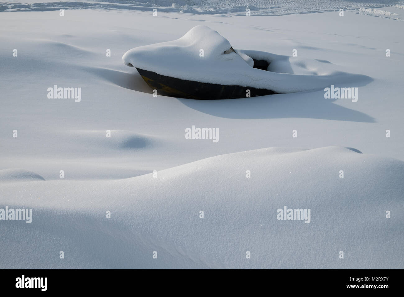 A boat frozen in port on the river Lena in Yakutsk, in Siberia is a ...