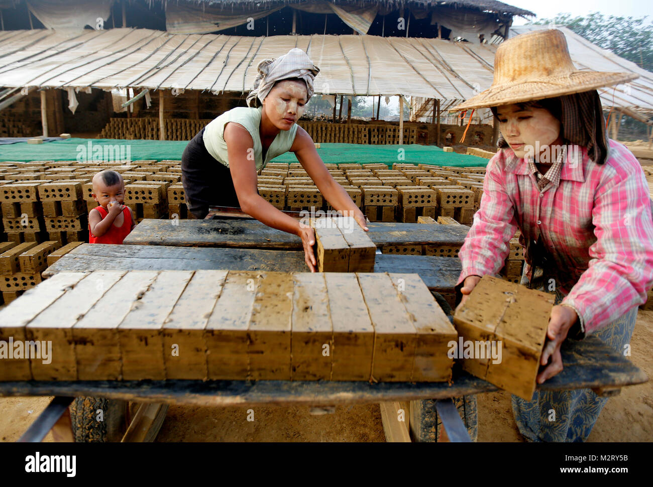 Yangon, Myanmar. 8th Feb, 2018. Laborers work at a brick factory on the ...