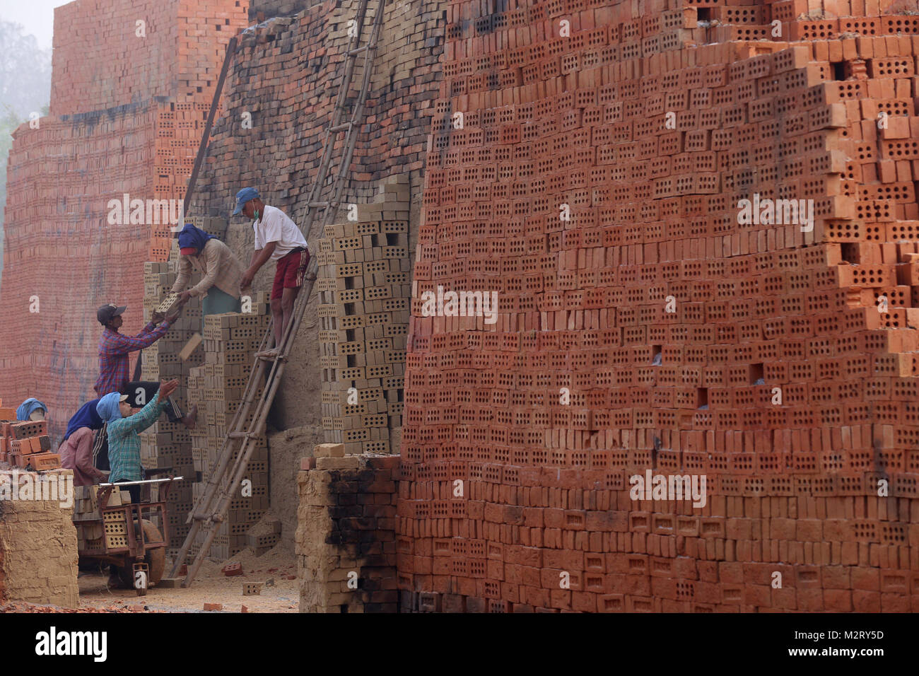 Yangon, Myanmar. 8th Feb, 2018. Laborers work at a brick factory on the ...
