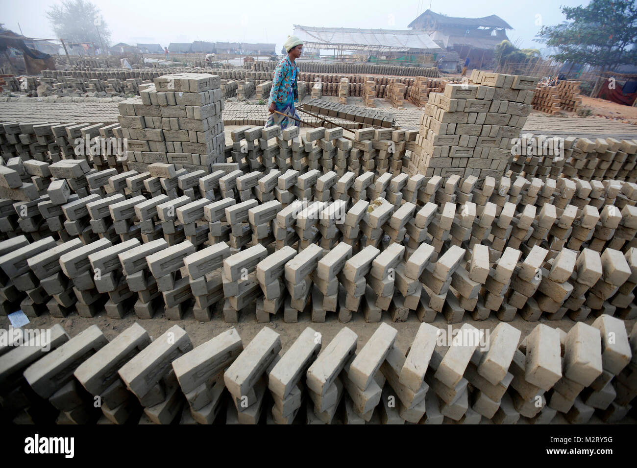 Yangon, Myanmar. 8th Feb, 2018. Laborers work at a brick factory on the outskirts of Yangon ...