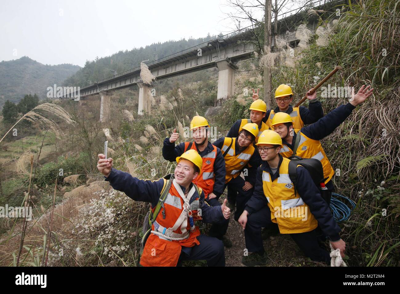 Chongqing, China. 7th Feb, 2018. Railway workers take selfie after work ...