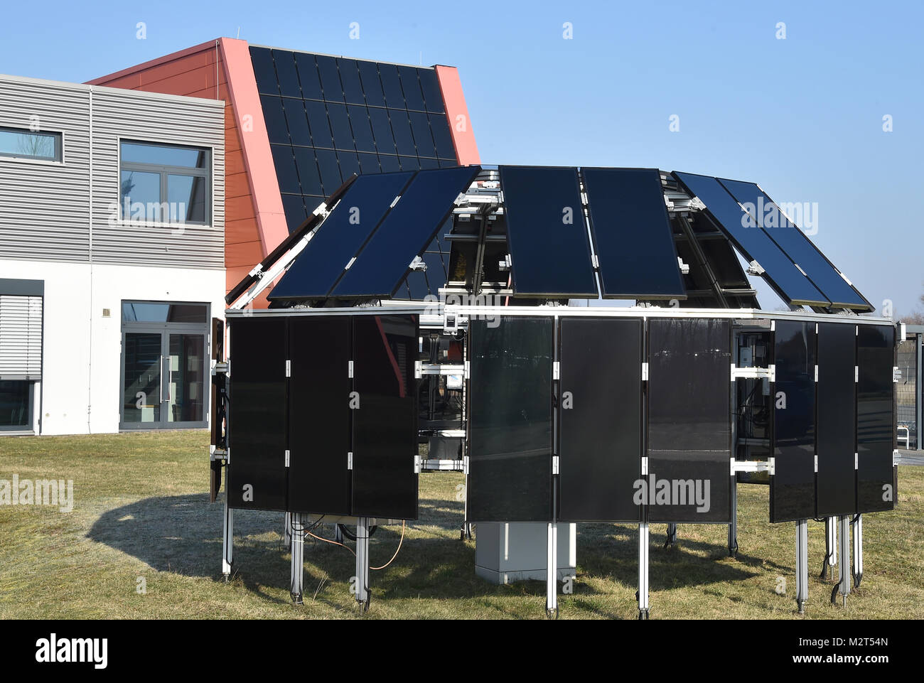 A solar some is assembled in front of a production building of ...