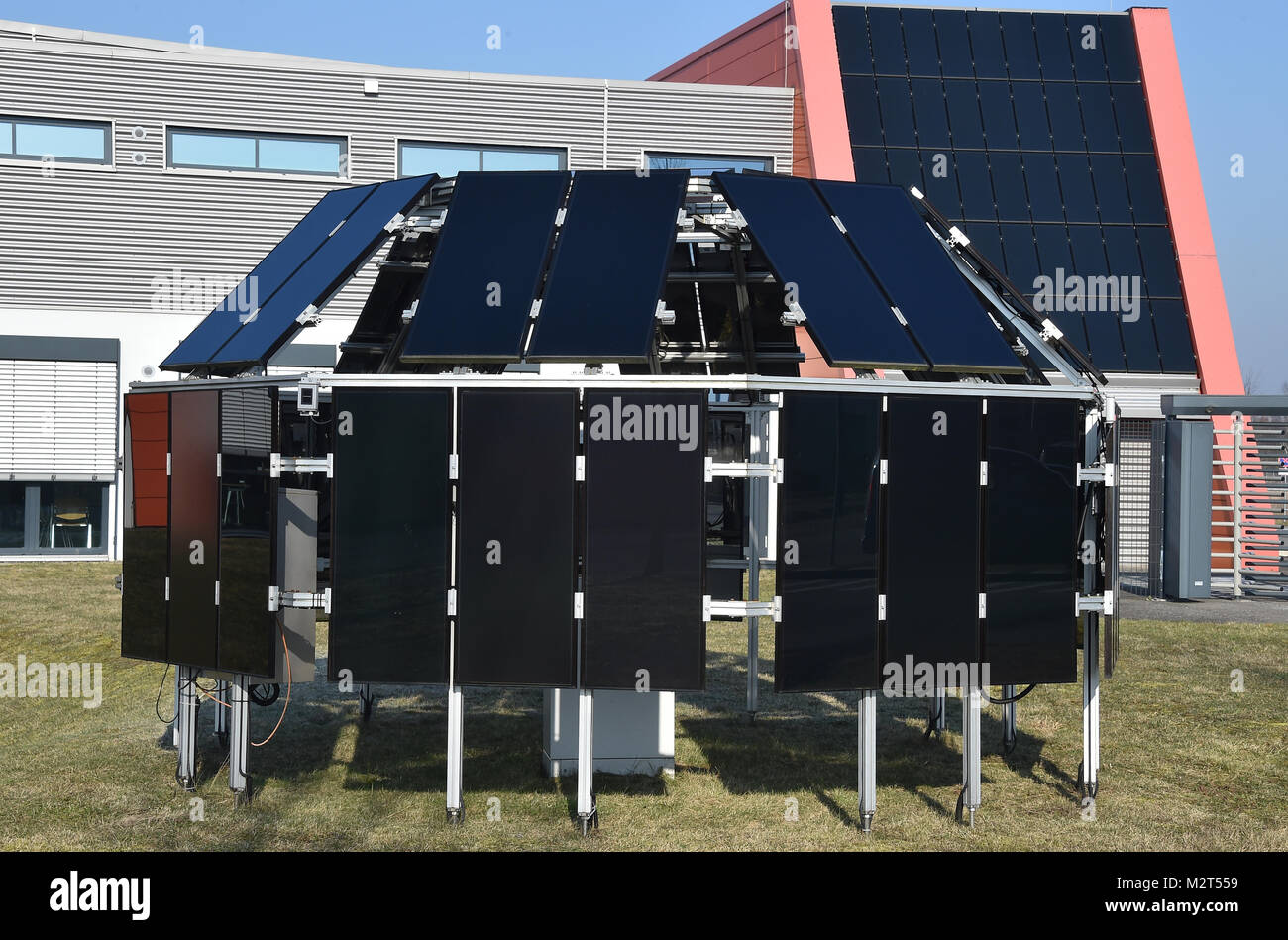 A solar some is assembled in front of a production building of ...