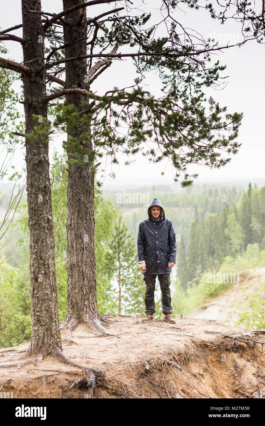 Man standing under trees Stock Photo - Alamy