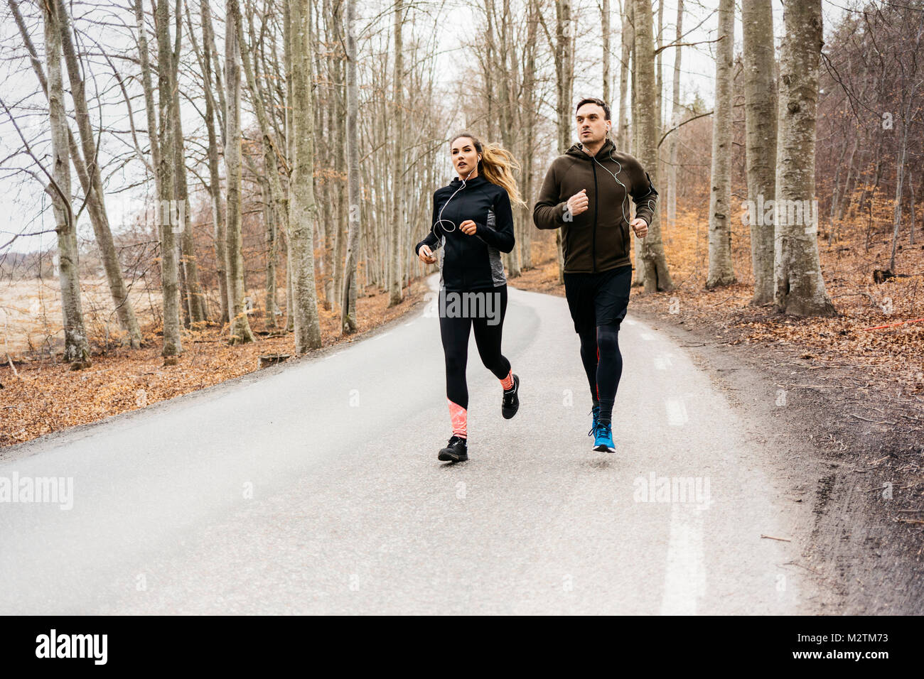 Young woman running along rural road hi-res stock photography and ...