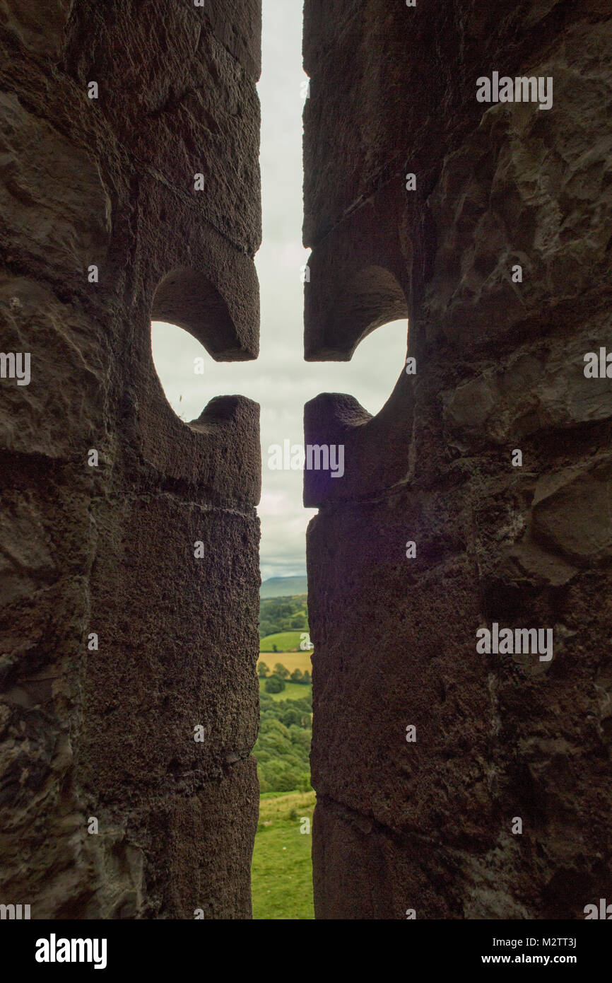 View through hole in wall of medieval castle on surrounding landscape ...