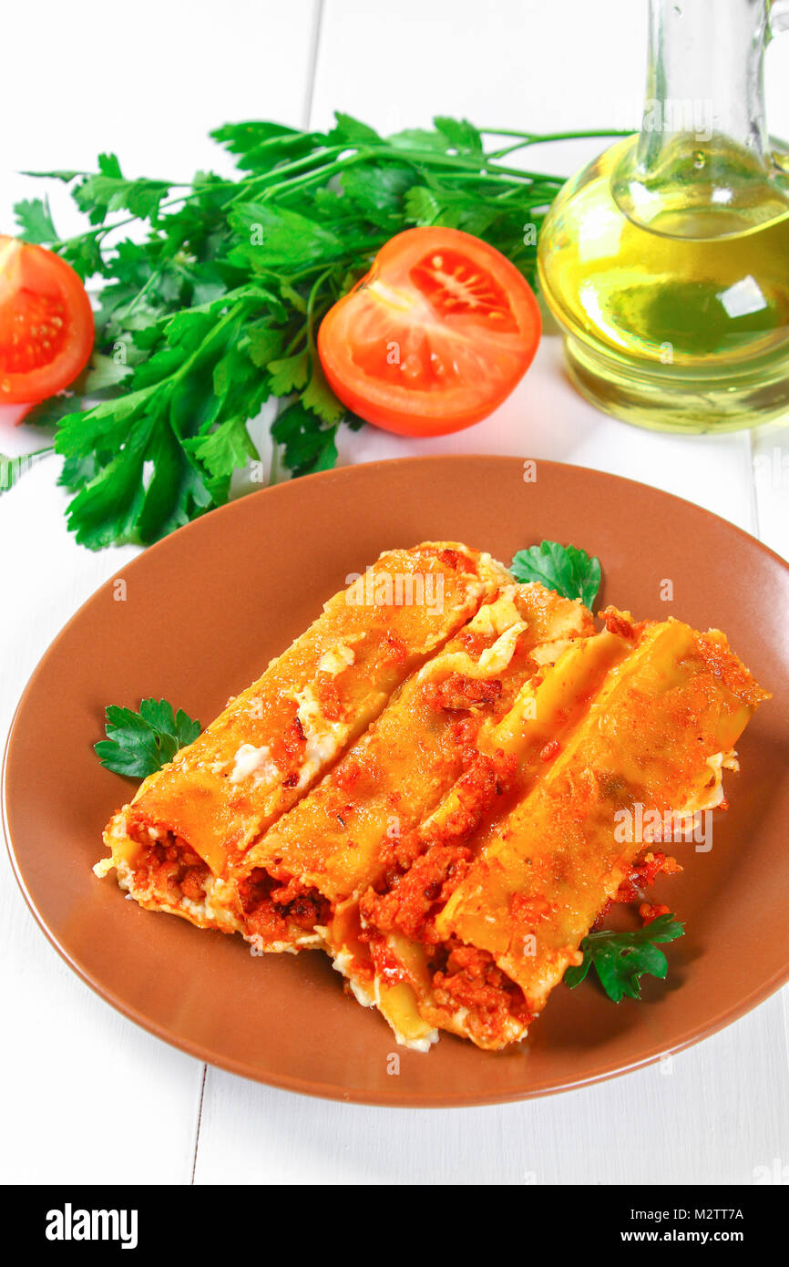 Traditional Italian pasta cannelloni. Baked tubes stuffed with minced ...