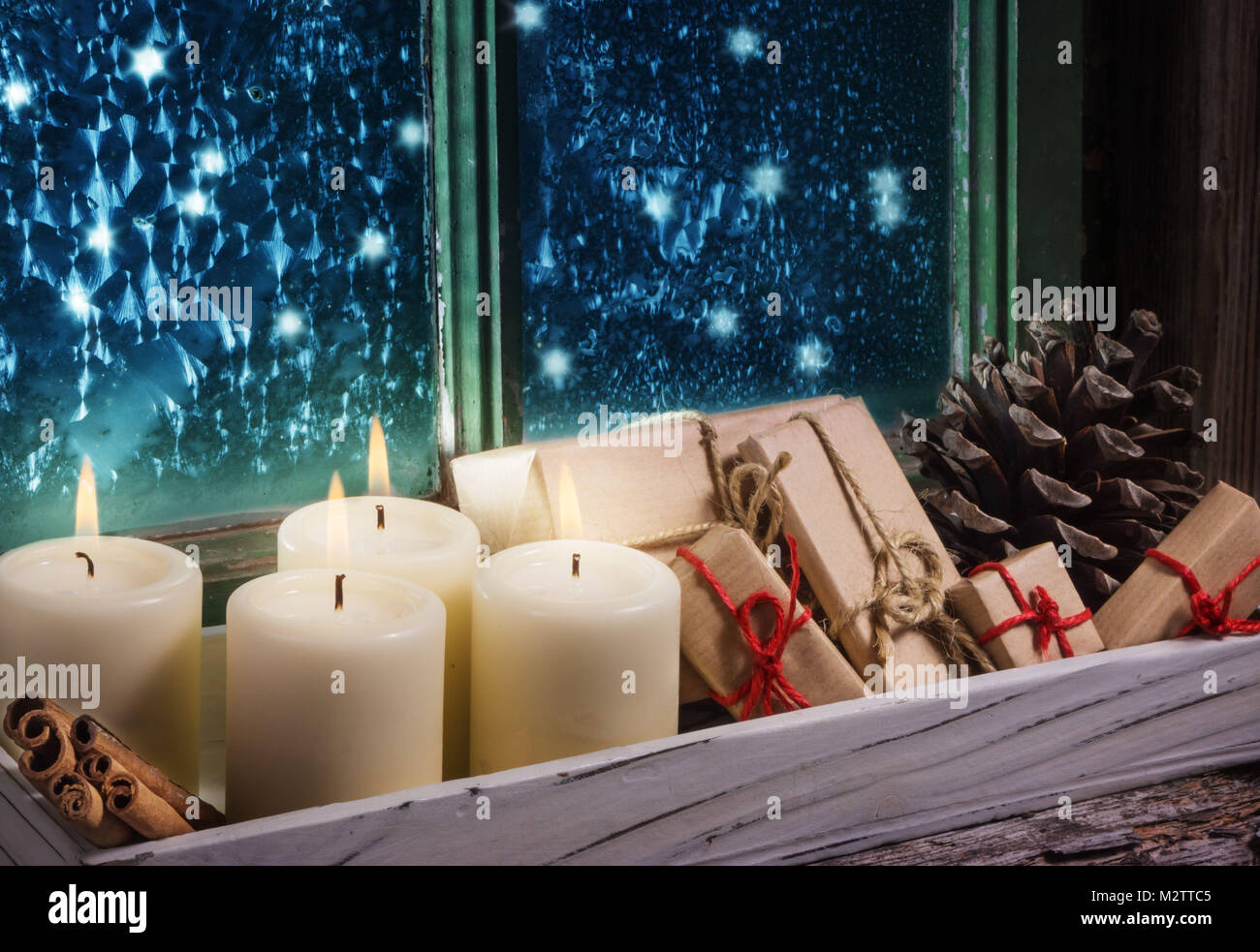 Gifts and Candles at the window Stock Photo - Alamy