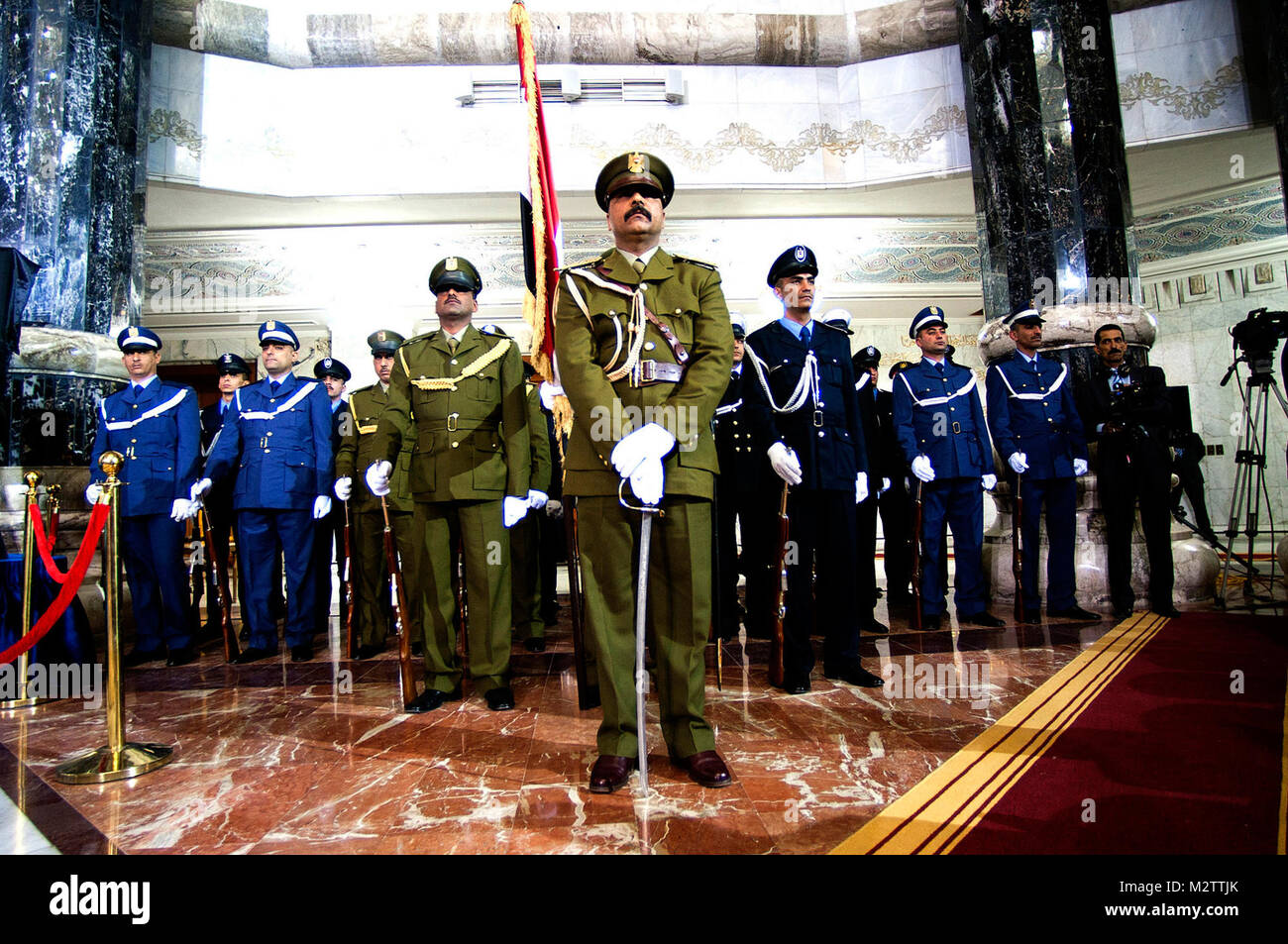 Iraqi military and police personnel stand in formation during the ...