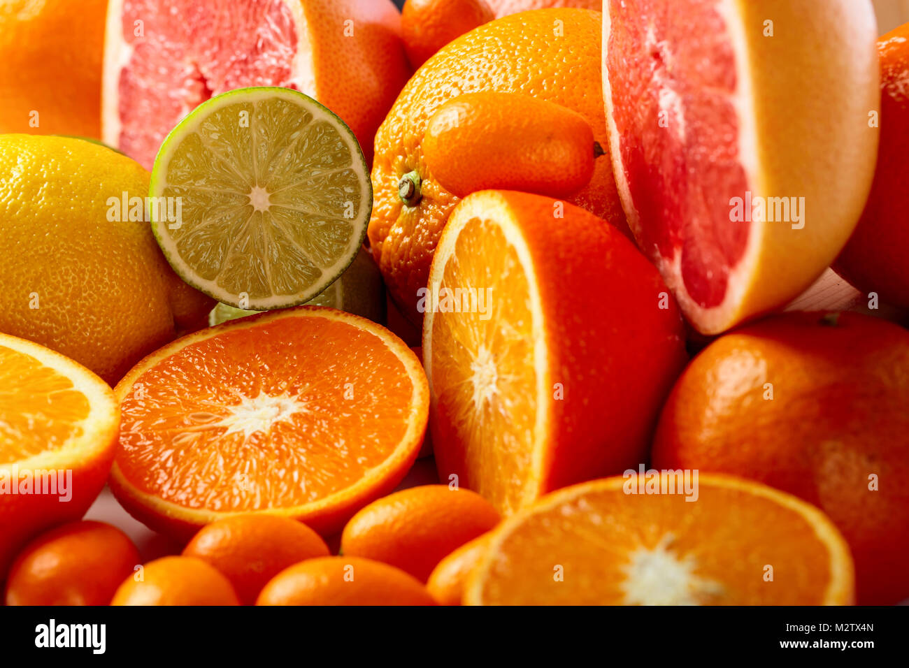 Close up of citrus fruits. Pieces of lemon, lime , tangerine , pink ...