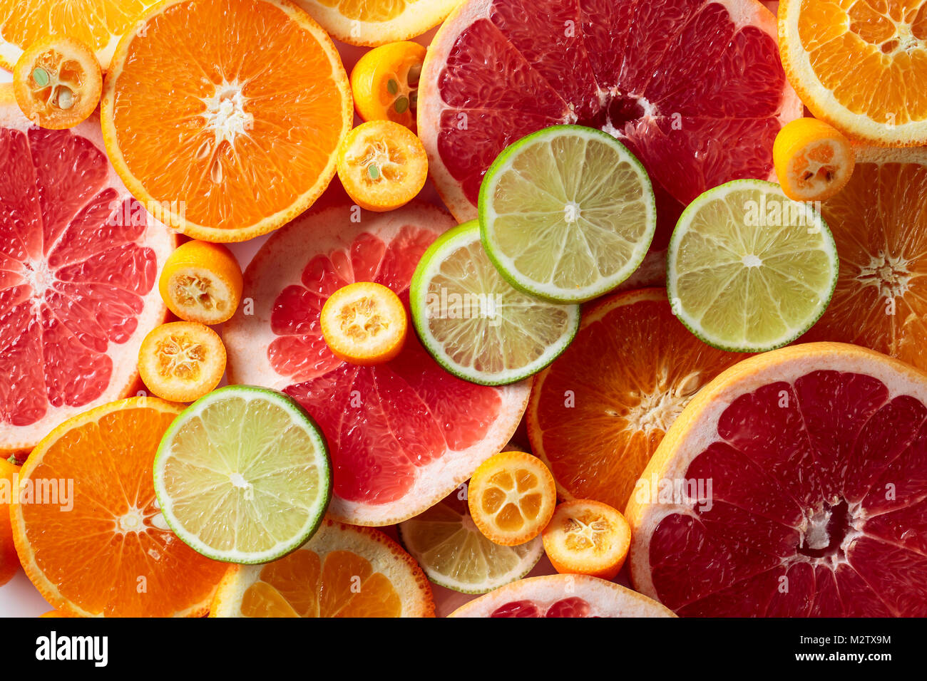 Close up of citrus fruits.. Pieces of lemon, lime , tangerine , pink ...