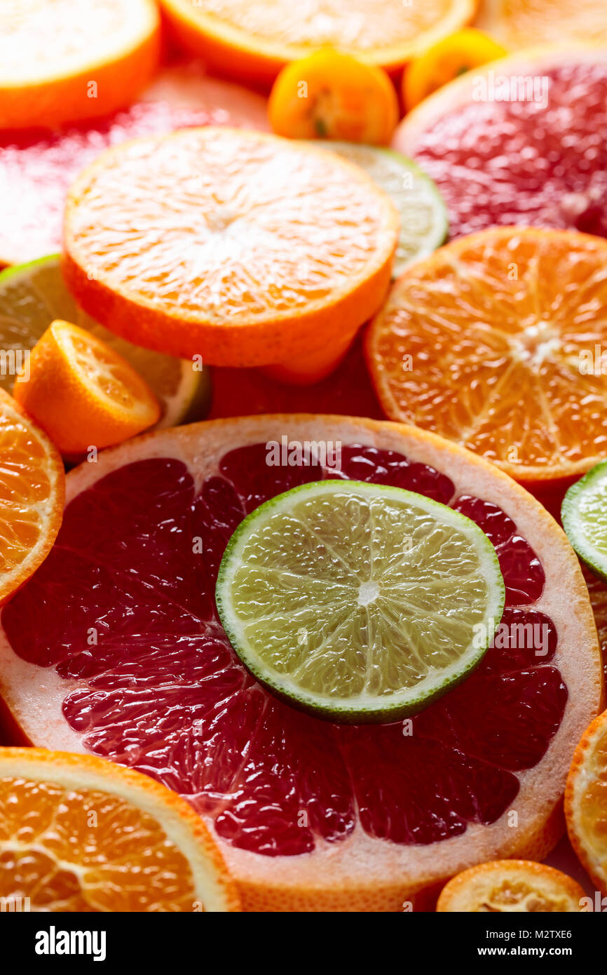 Close up of citrus fruits. Pieces of lemon, lime , tangerine , pink ...