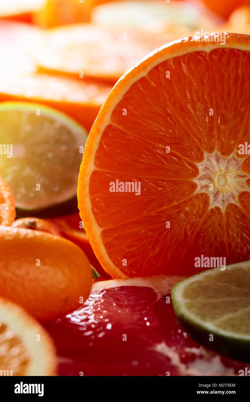 Close up of citrus fruits. Pieces of lemon, lime , tangerine , pink ...
