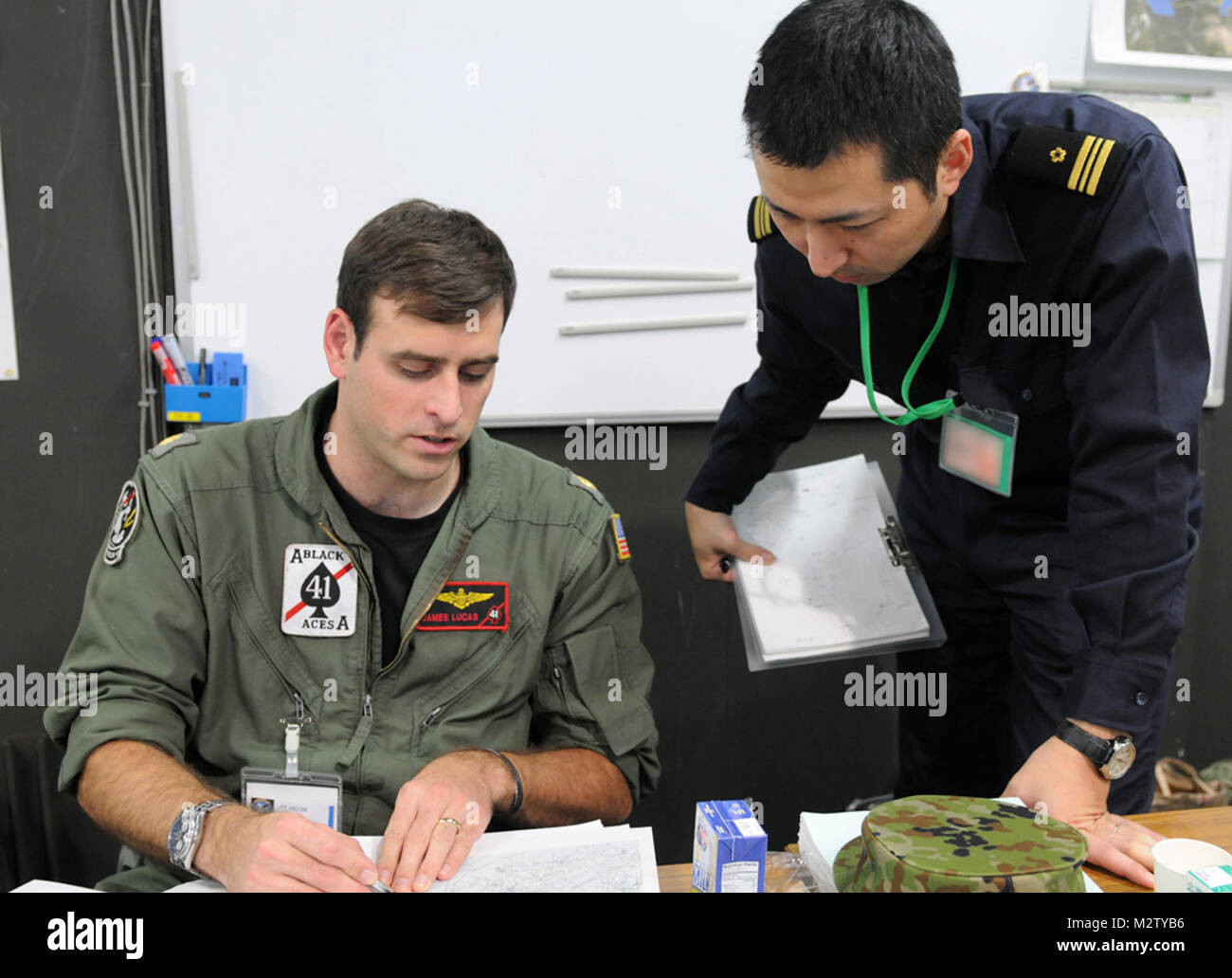 Lt. Cmdr. James Lucas (left), a Joint Task Force Maritime Component ...