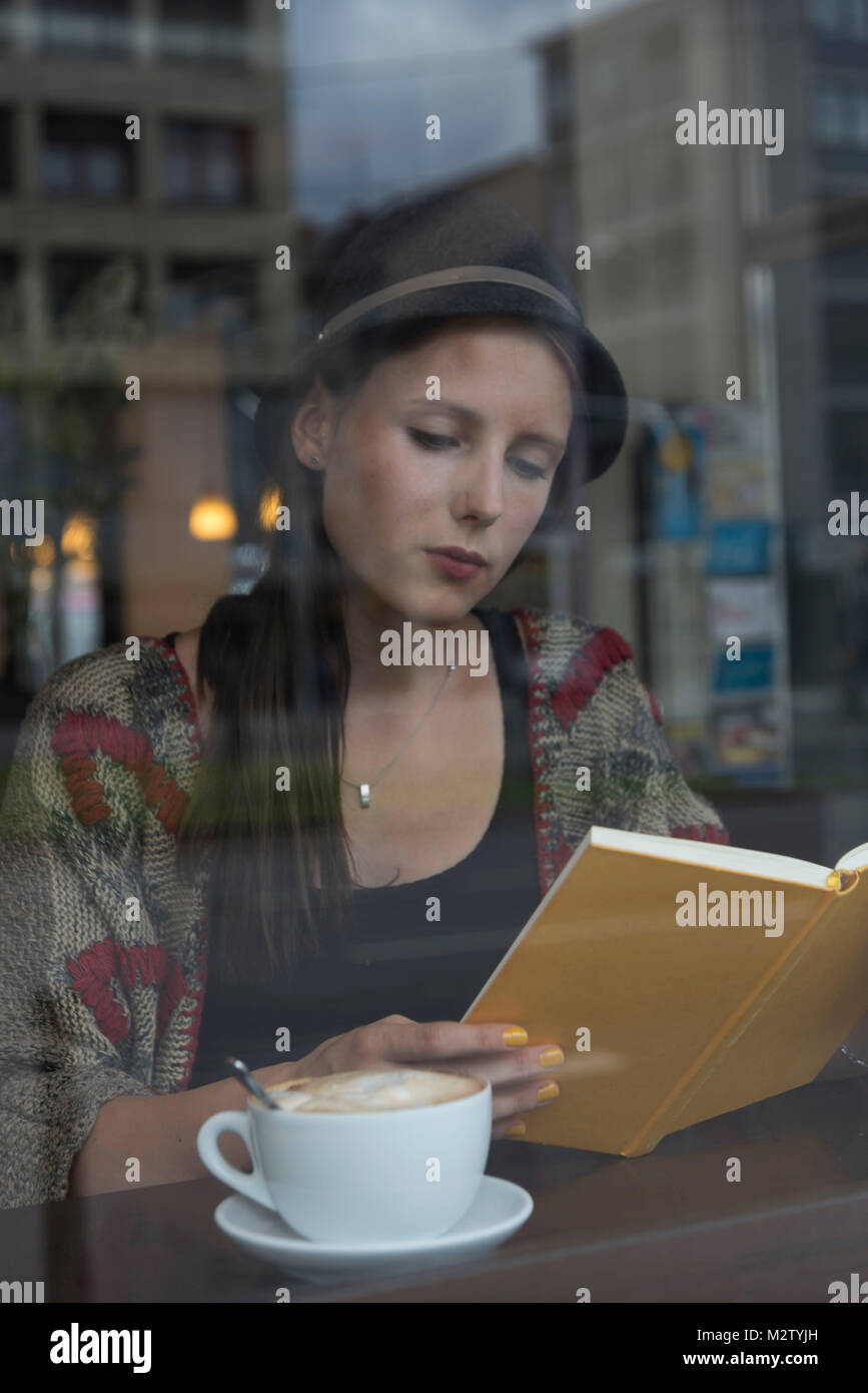 Young woman behind window in the café, semi-portrait Stock Photo - Alamy