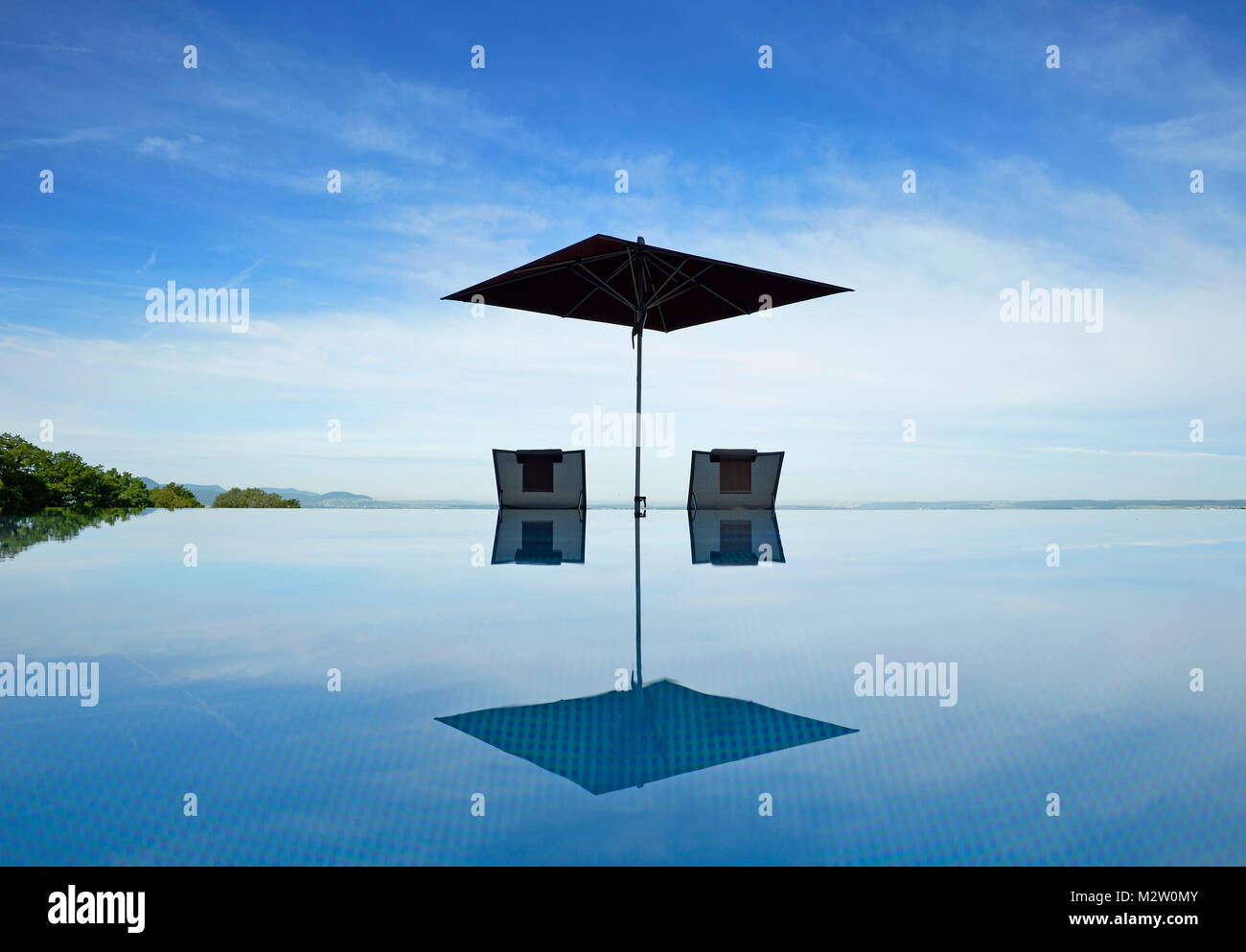 Sunshade and loungers are reflecting in hotel pool, Burg Staufeneck ...