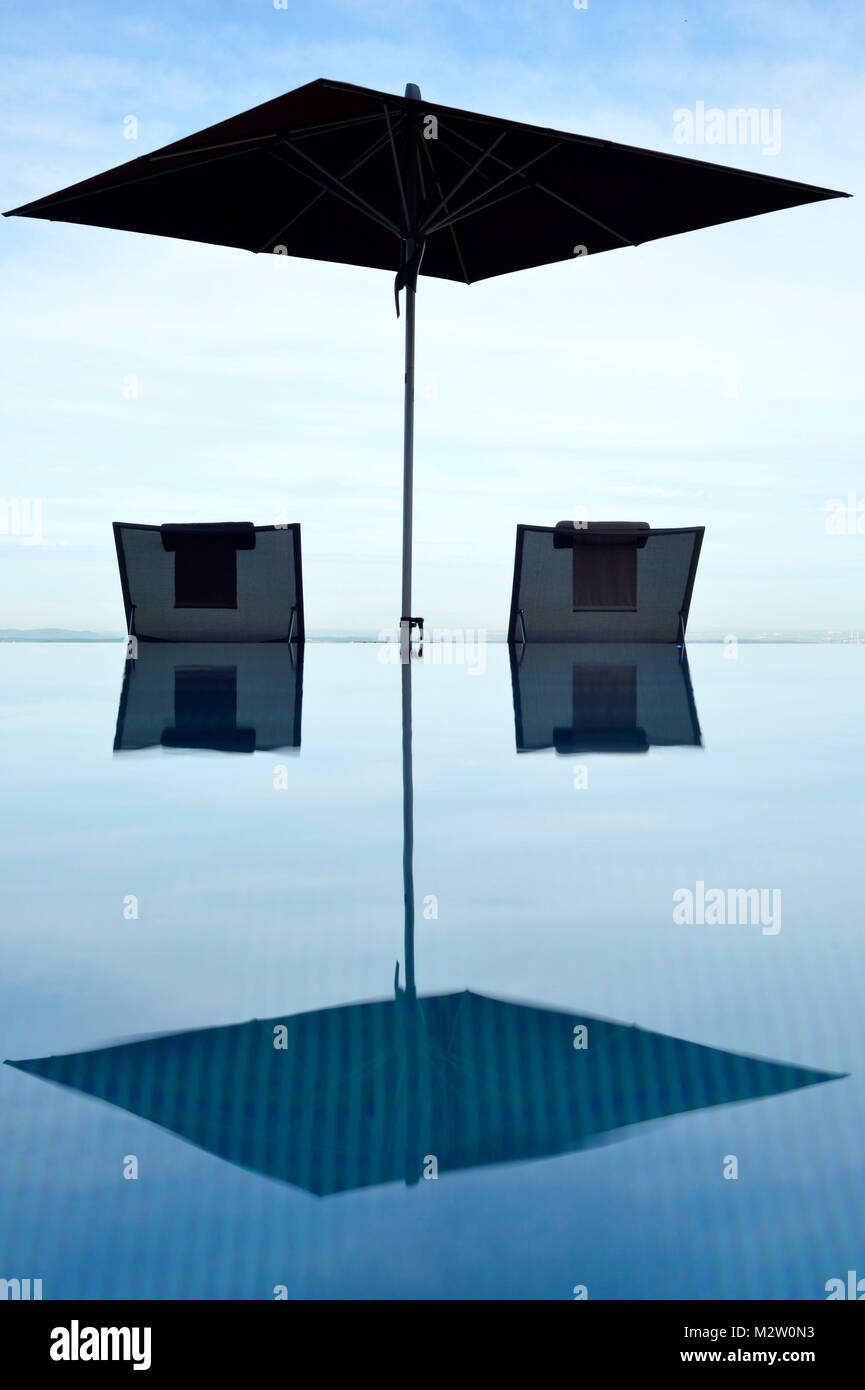 Sunshade and loungers are reflecting in hotel pool, Burg Staufeneck ...