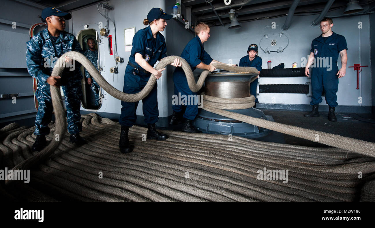 Sailors apply turns a capstan in the officer's brow on the Nimitz-class ...