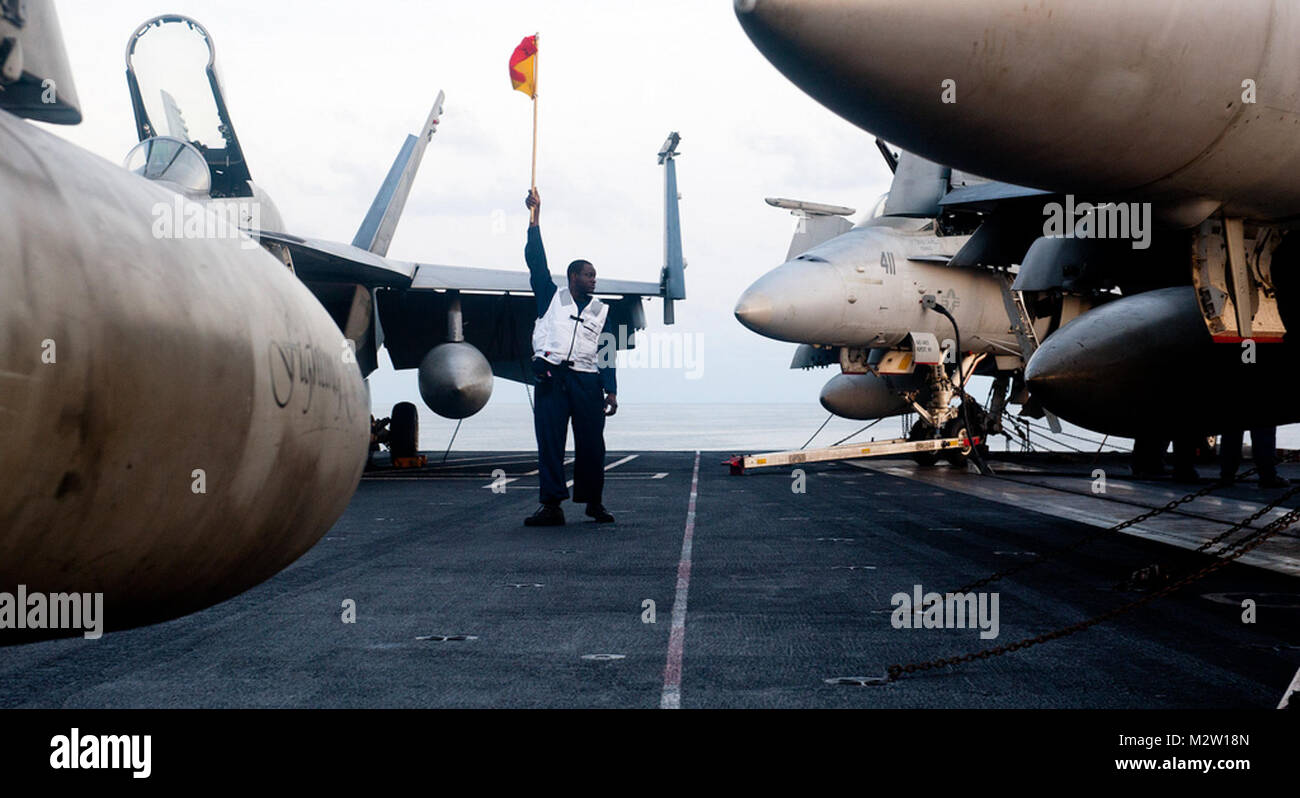 Quartermaster carries the signal flag during a replenishment at sea by ...